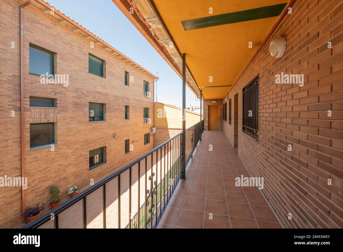 Old corral style corridors of an access building to independent houses ...