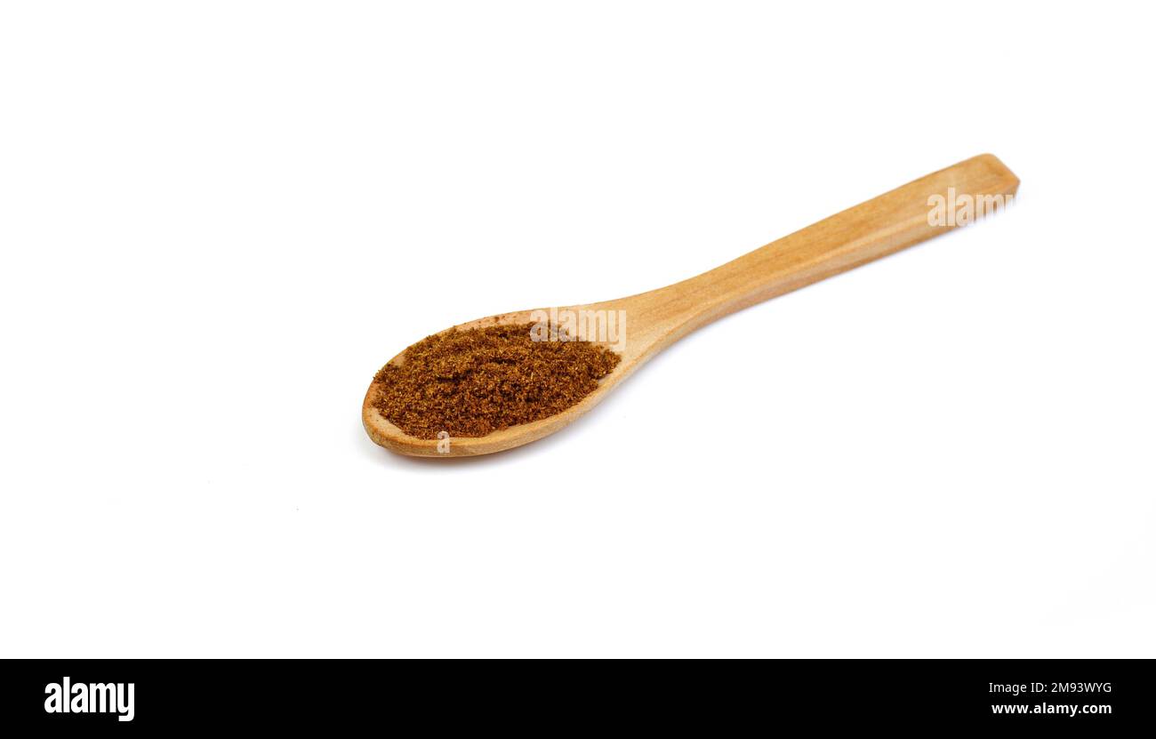 Pile of Garam Masala in a wooden spoon isolated on white background ...