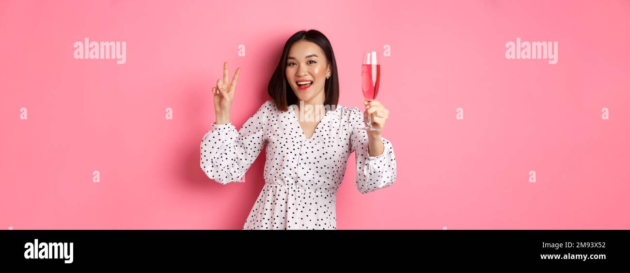 Cute asian female model drinking champagne, celebrating on party and ...