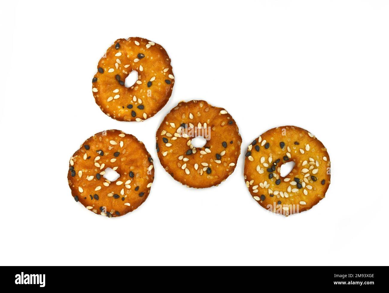 Salted round pretzels with black and white sesame isolated on white ...