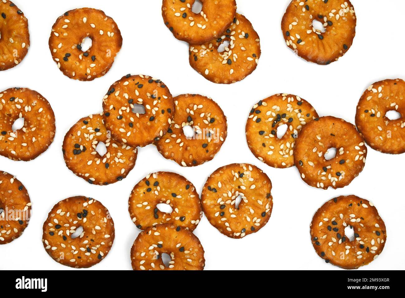 Salted round pretzels with black and white sesame isolated on white ...