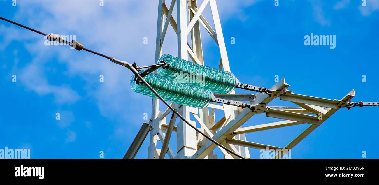 Line insulator on the electrical wires of a high-voltage tower ...