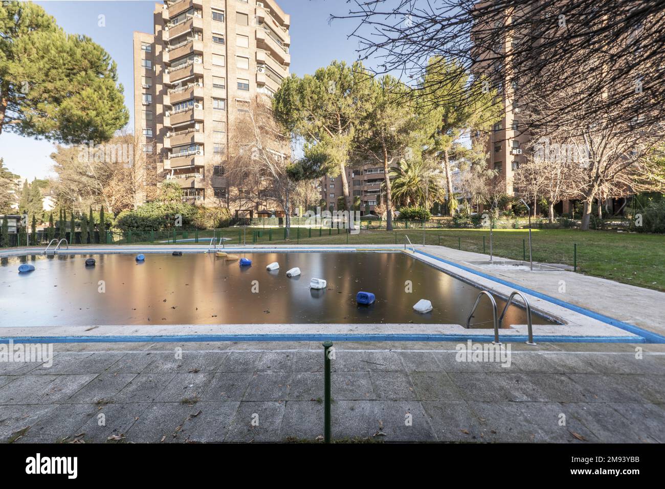A summer pool in a community garden with the surface of the water ...
