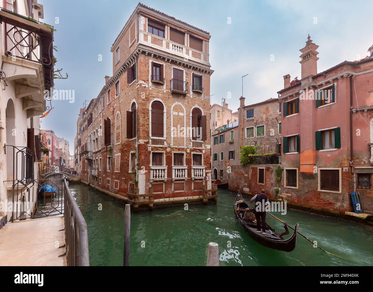 Facades of traditional medieval colorful houses along the canal at ...