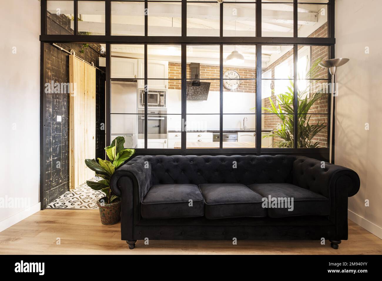 Living room with a three-seater chester sofa upholstered in black ...