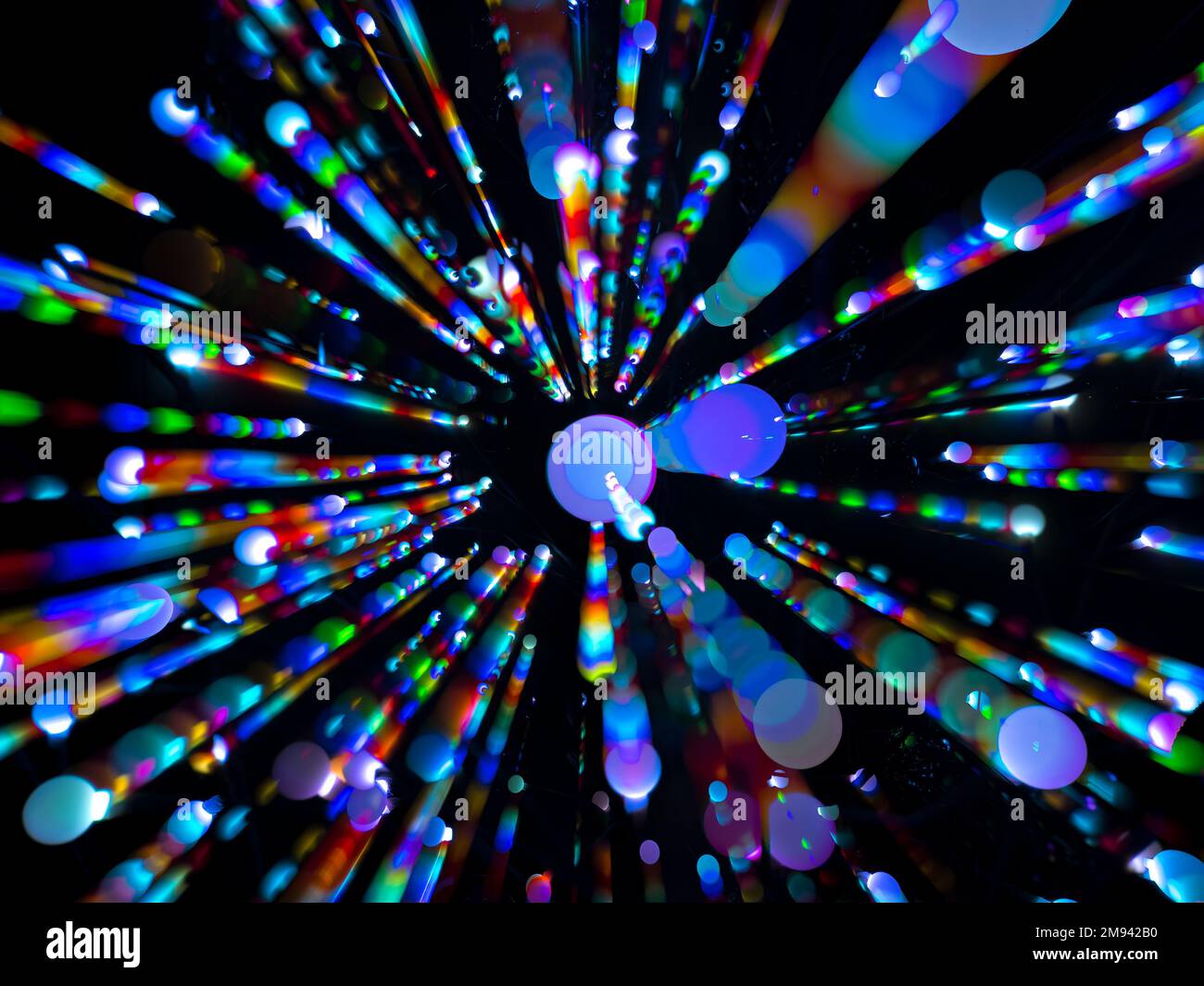 Colorful abstract circles in a radiating pattern against a black ...