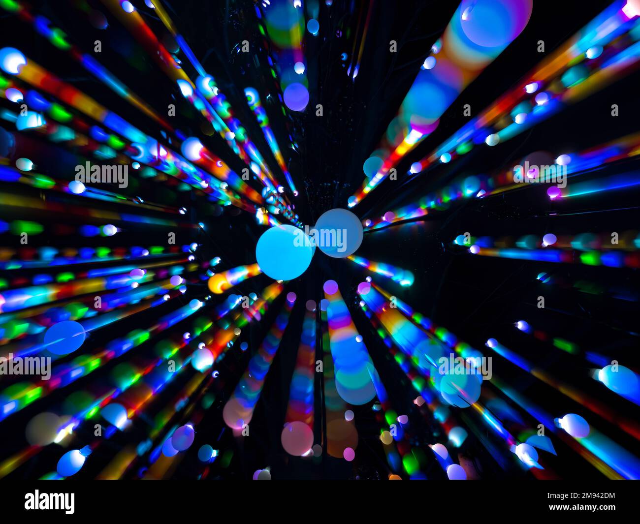 Colorful abstract circles in a radiating pattern against a black ...