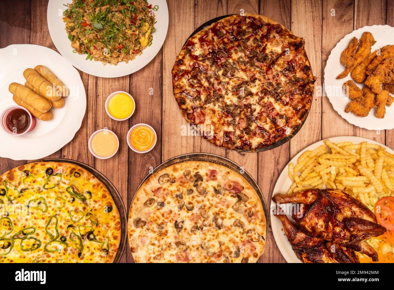 A top view photo of a bunch of assorted pizzas cooked in a stone oven ...