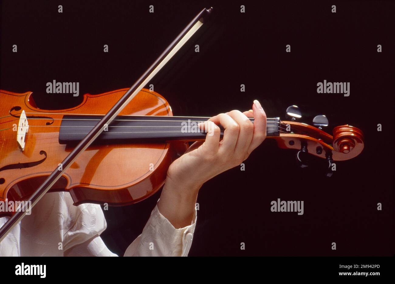 Close-up of a woman playing a violin with hands on the strings Stock ...
