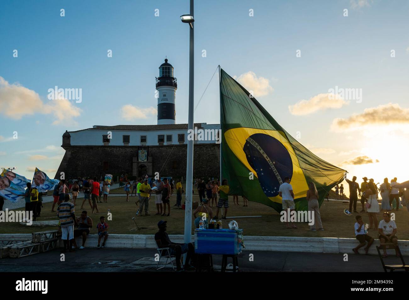 A group of people holding up a large Brazilian flag in the air during a ...