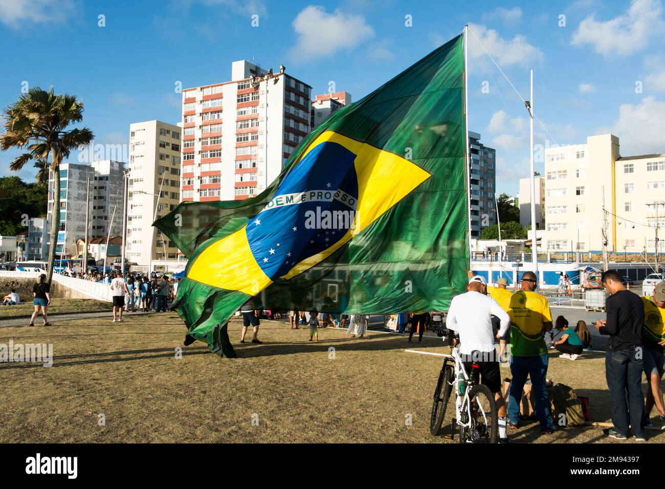 A group of people holding up a large Brazilian flag in the air during a ...