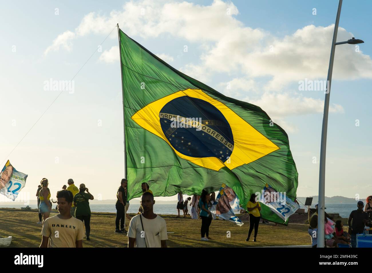 A group of people holding up a large Brazilian flag in the air during a ...