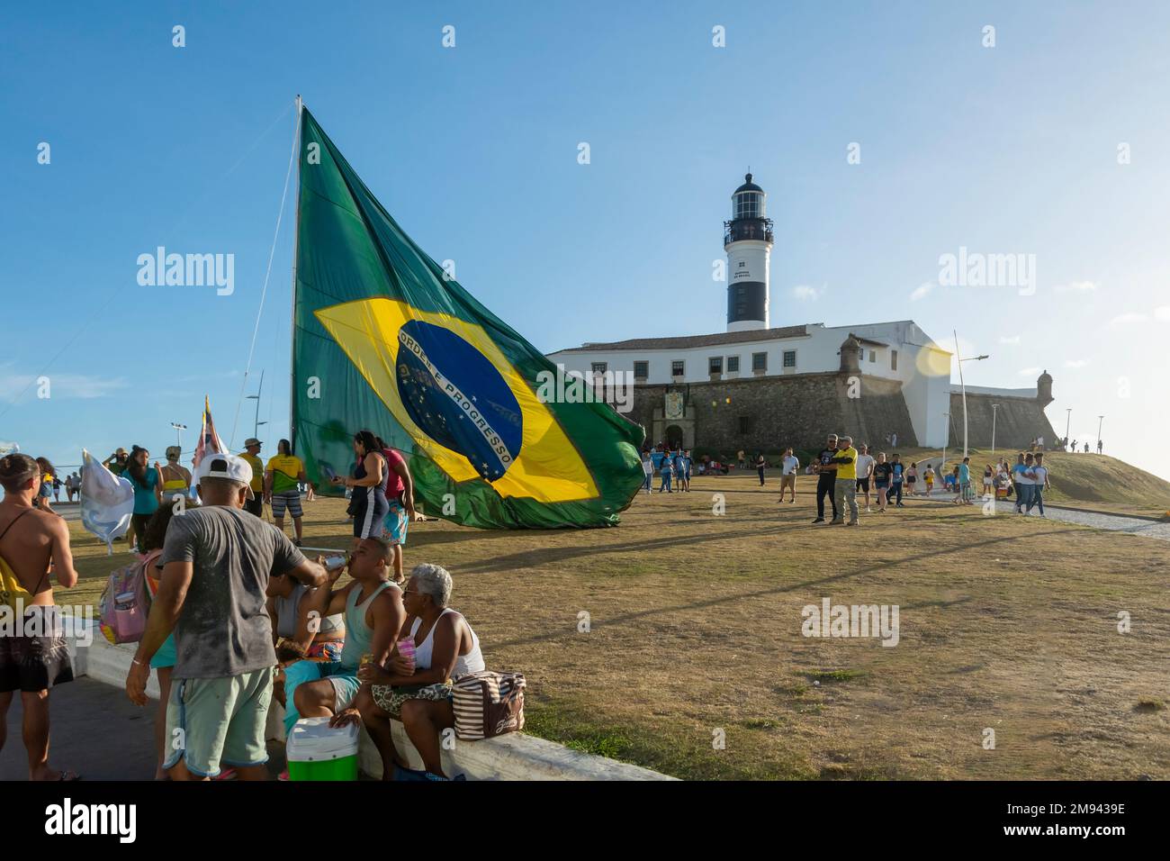 A group of people holding up a large Brazilian flag in the air during a ...