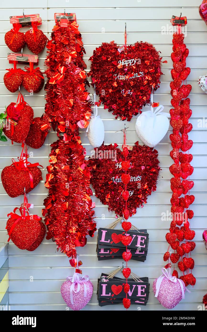 Valentine`s Day hearts and garland decorations displayed on a store ...
