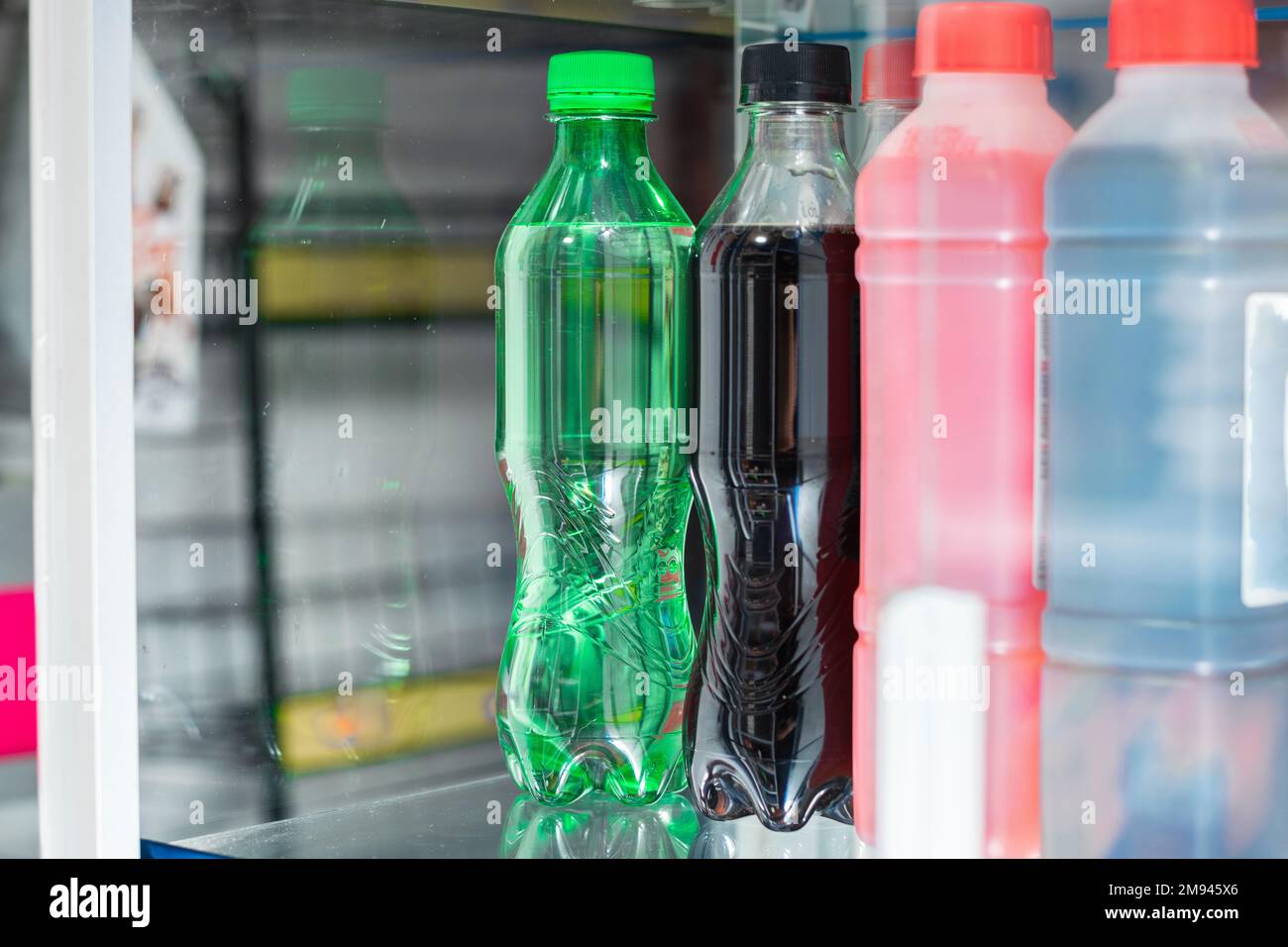 close-up of four soft drinks, placed on a glass display case. shortage ...