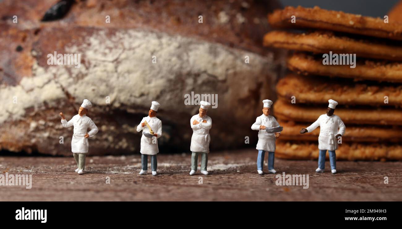 Roasted bread and five miniature chefs. Miniature people and business ...