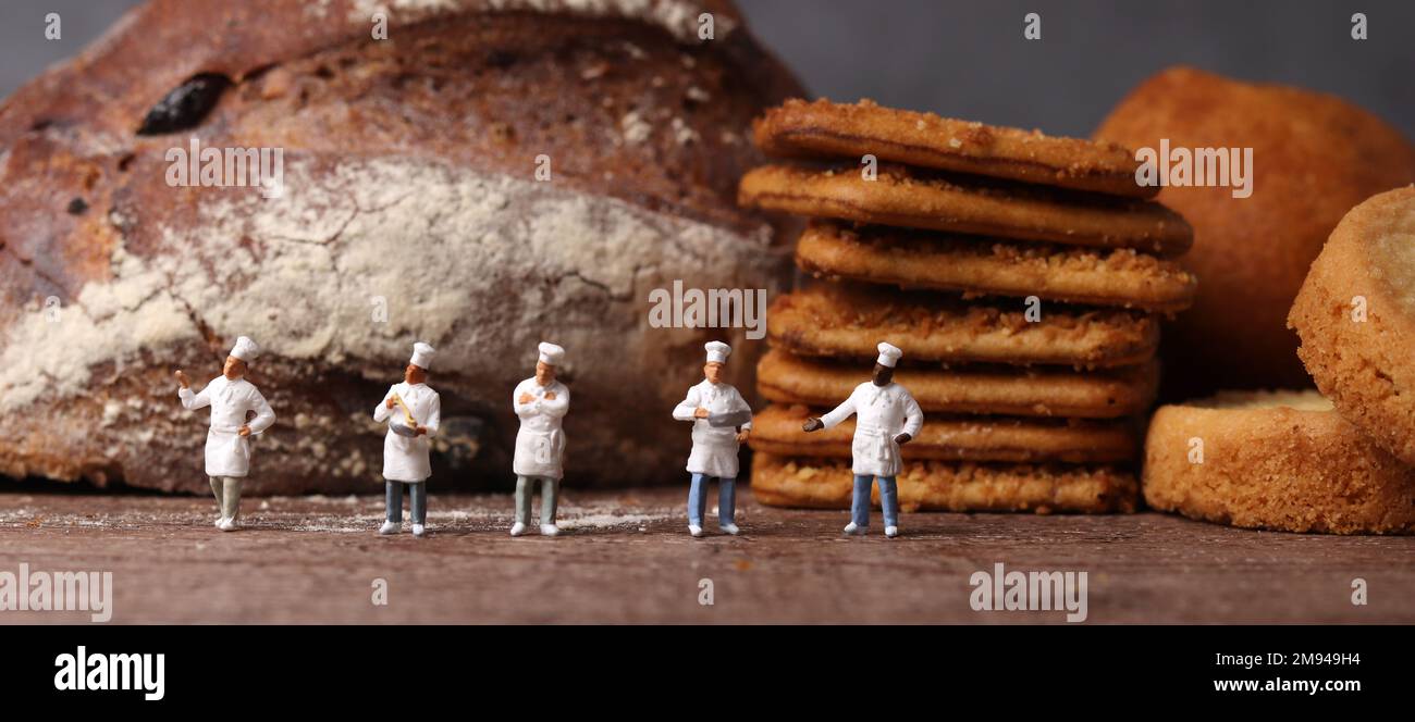 Roasted bread and five miniature chefs. Miniature people and business ...