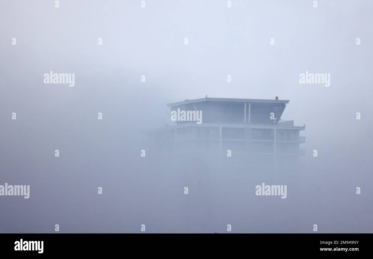 High Rise Luxury Apartment Building and Rooftop Helipad in Dense Fog ...