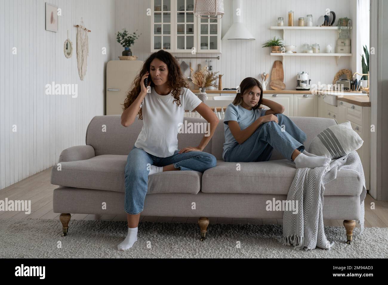 Stressed, nervous mother talking by phone complaining about bad ...