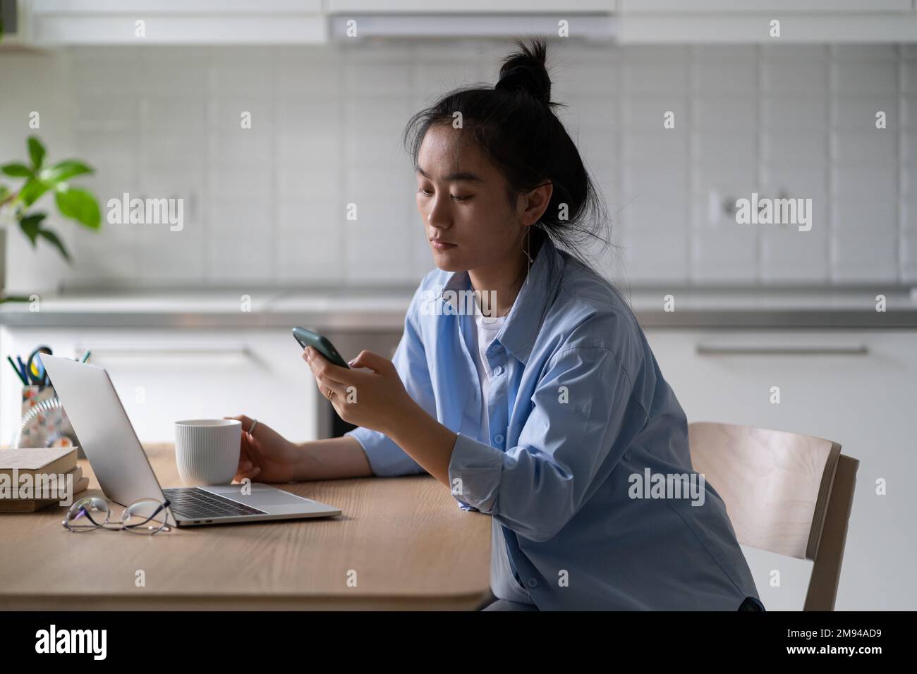 Worried upset Asian woman remote worker receiving unpleasant text ...