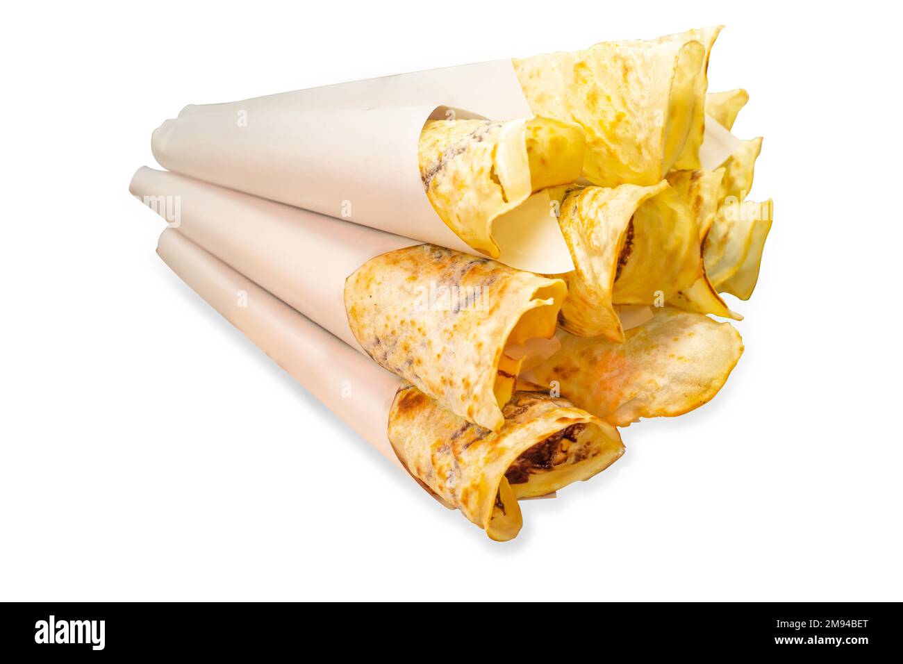Die cut of Crispy fried thin roti with sweetened condensed milk on top ...