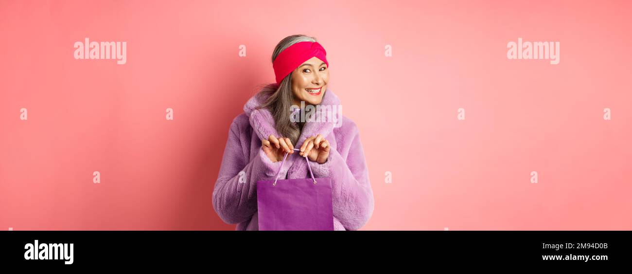 Shopping and fashion concept. Fashionable gradmother bought present and ...