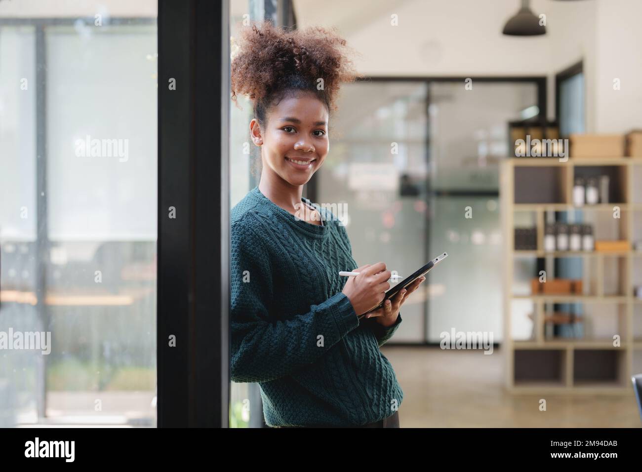 Young black curly hair American African woman using digital tablet ...