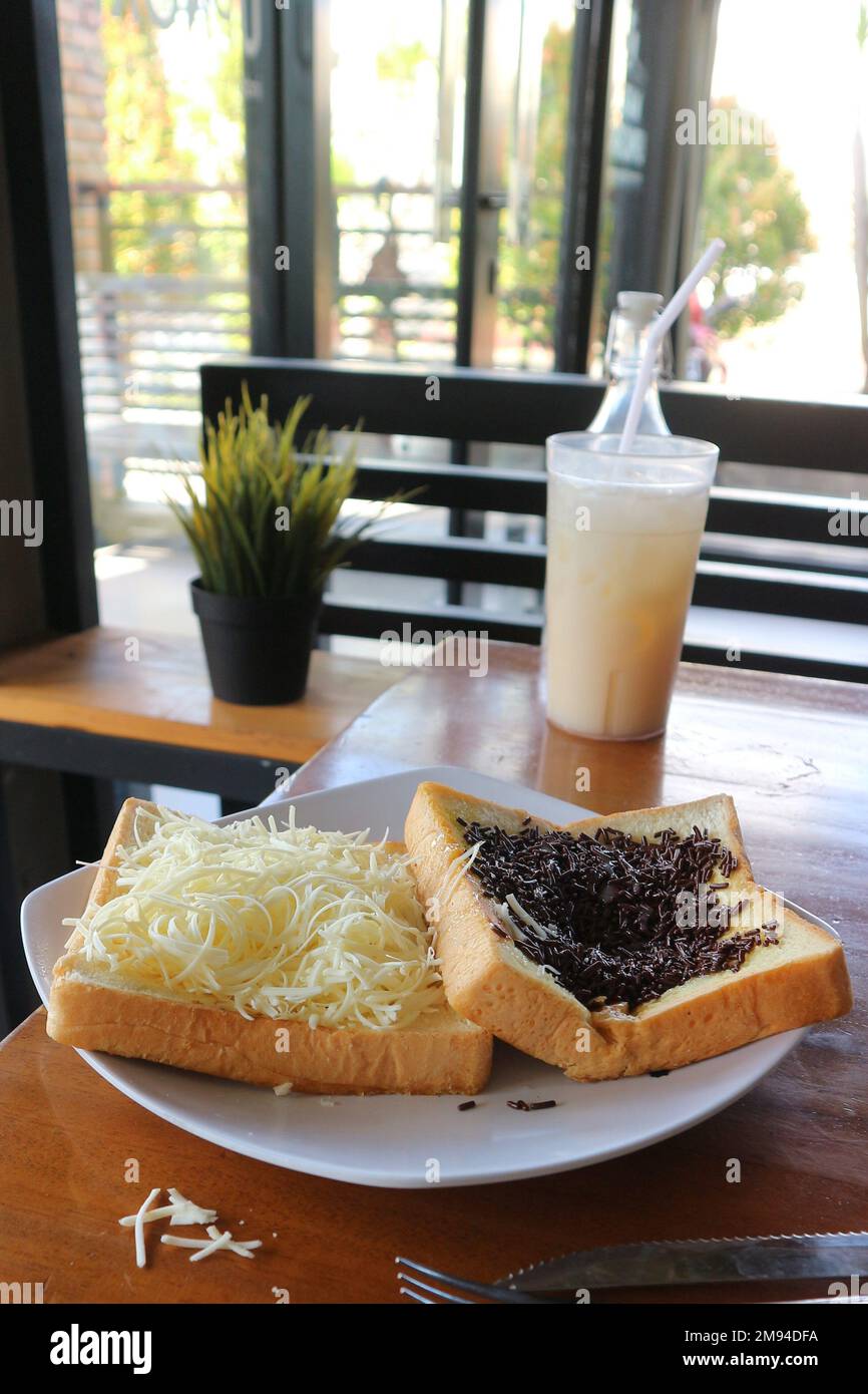 toast with cheese and chocolate sprinkles on a white plate served with ...