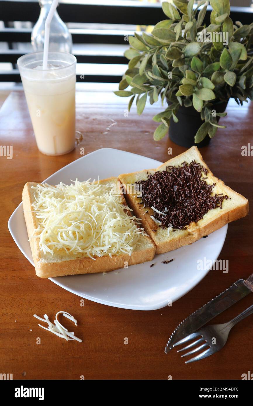 toast with a sprinkling of cheese and chocolate sprinkles on a white ...