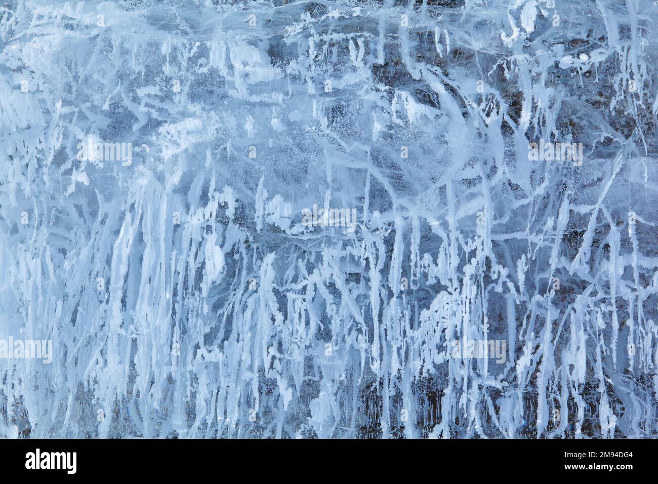 Texture of winter ice on a stone cliff. Blue natural ice background ...