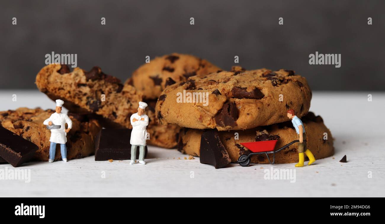 A miniature farmer dragging cart and two miniature chefs with chocolate ...