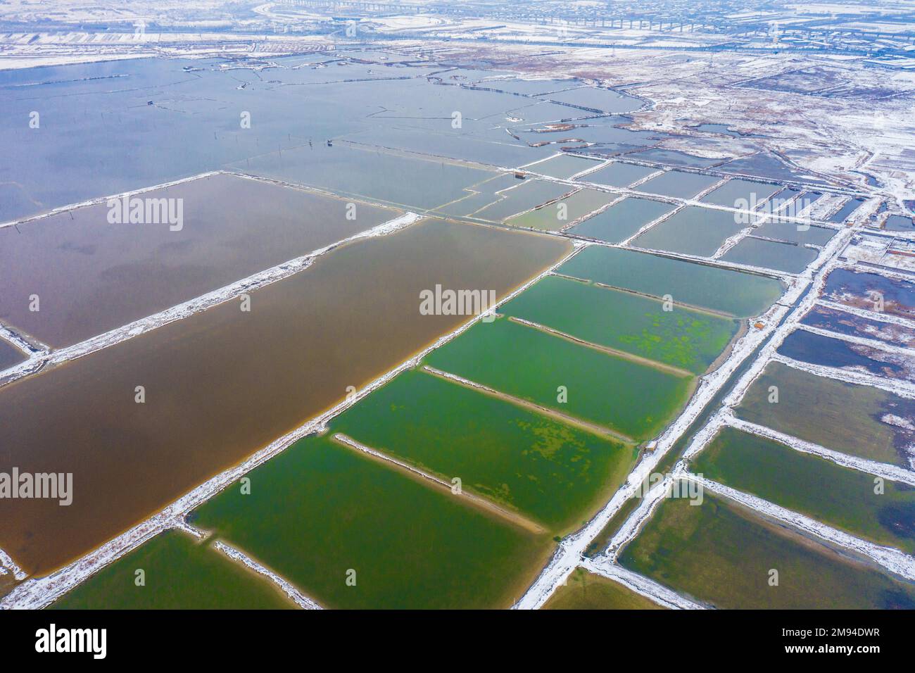 Aerial photo shows the snow scenery of colorful salt lake in Yuncheng ...