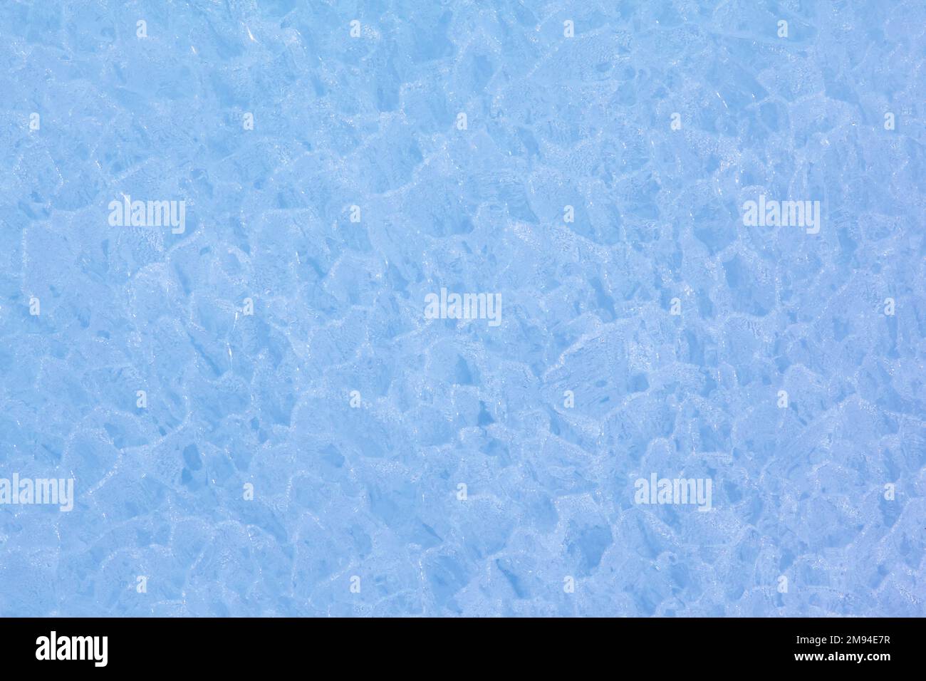 Texture of winter ice surface in the form of polygonal patterns. Blue ...