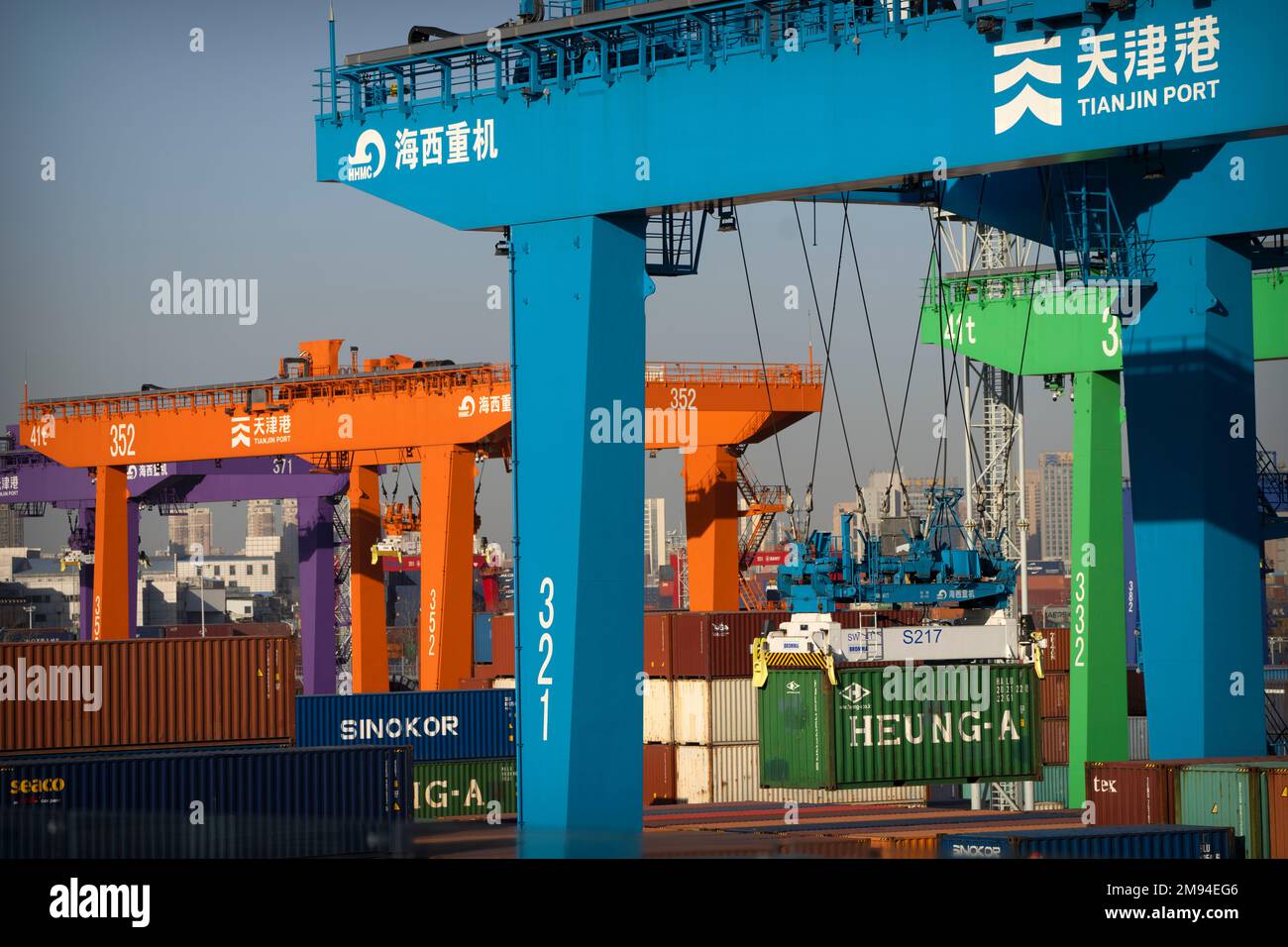 A crane lifts a shipping container at an automated container port in ...