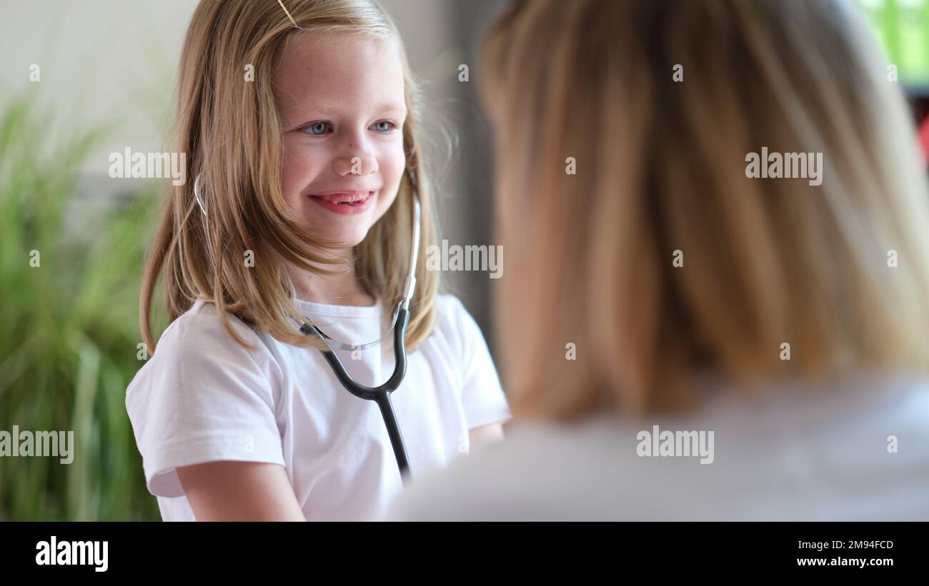 Family doctor lets her young patient play with stethoscope Stock Photo ...