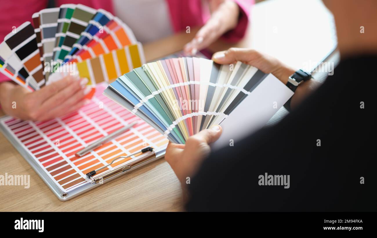 Designer helps client choose colors for project from variety Stock ...