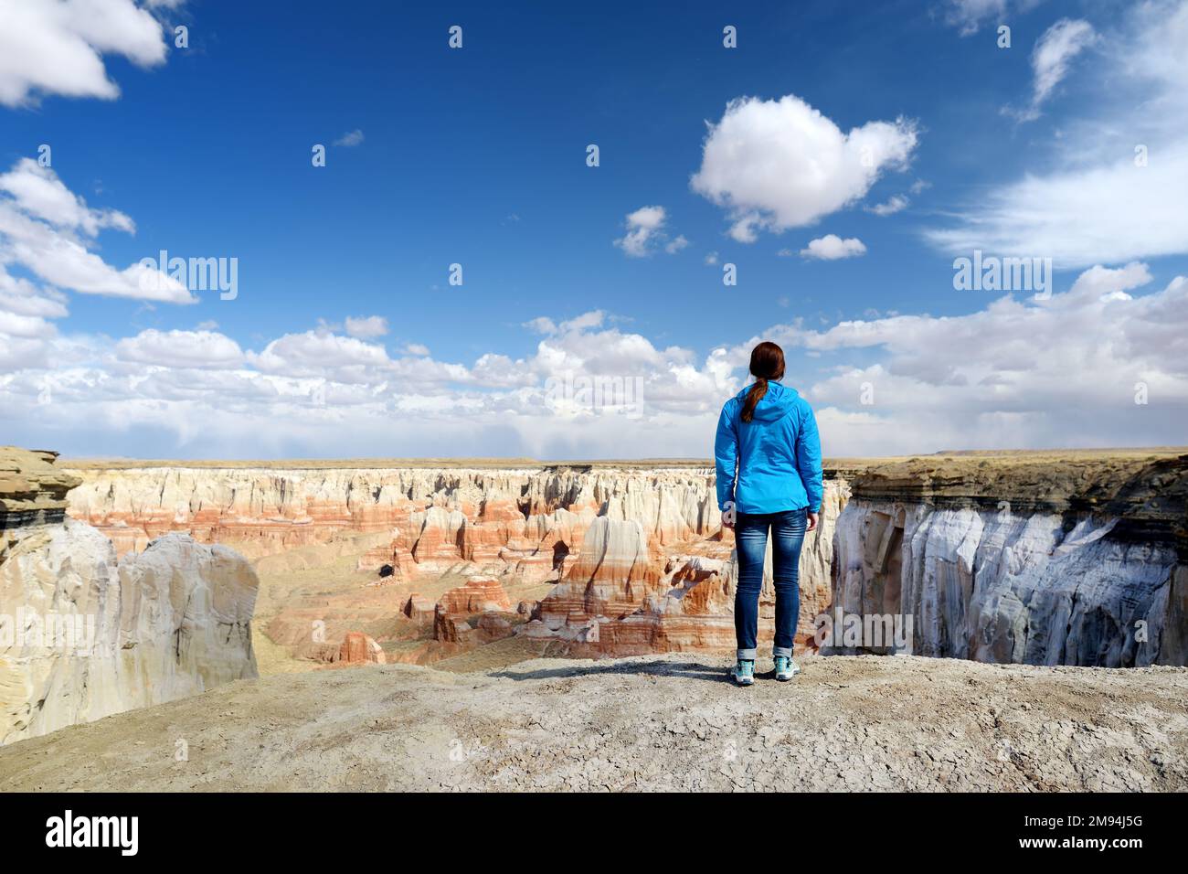Young female hiker admiring views of stunning striped sandstone ...