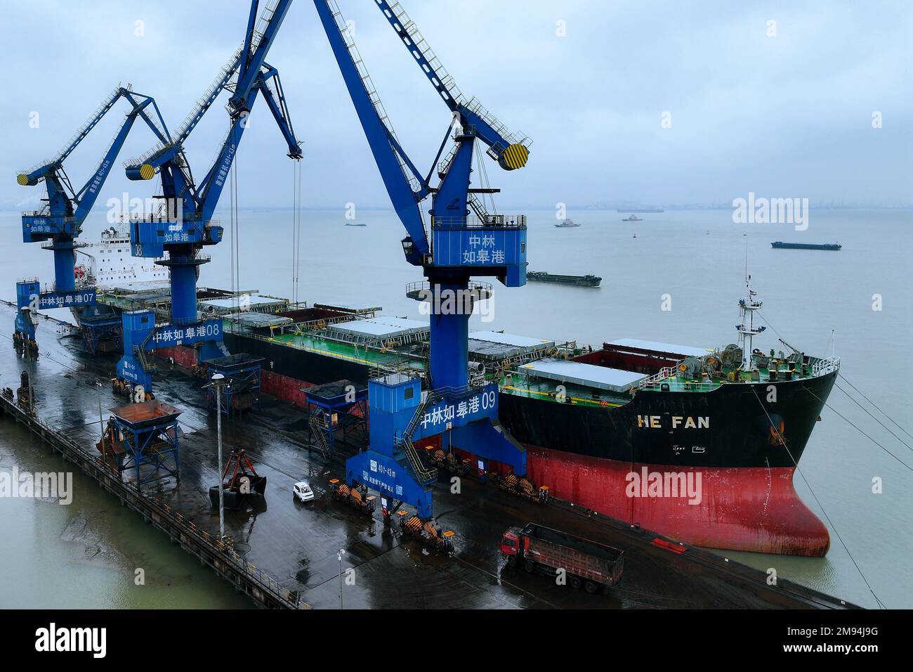 Aerial photo shows large machineries unloading thermal coal at the coal ...