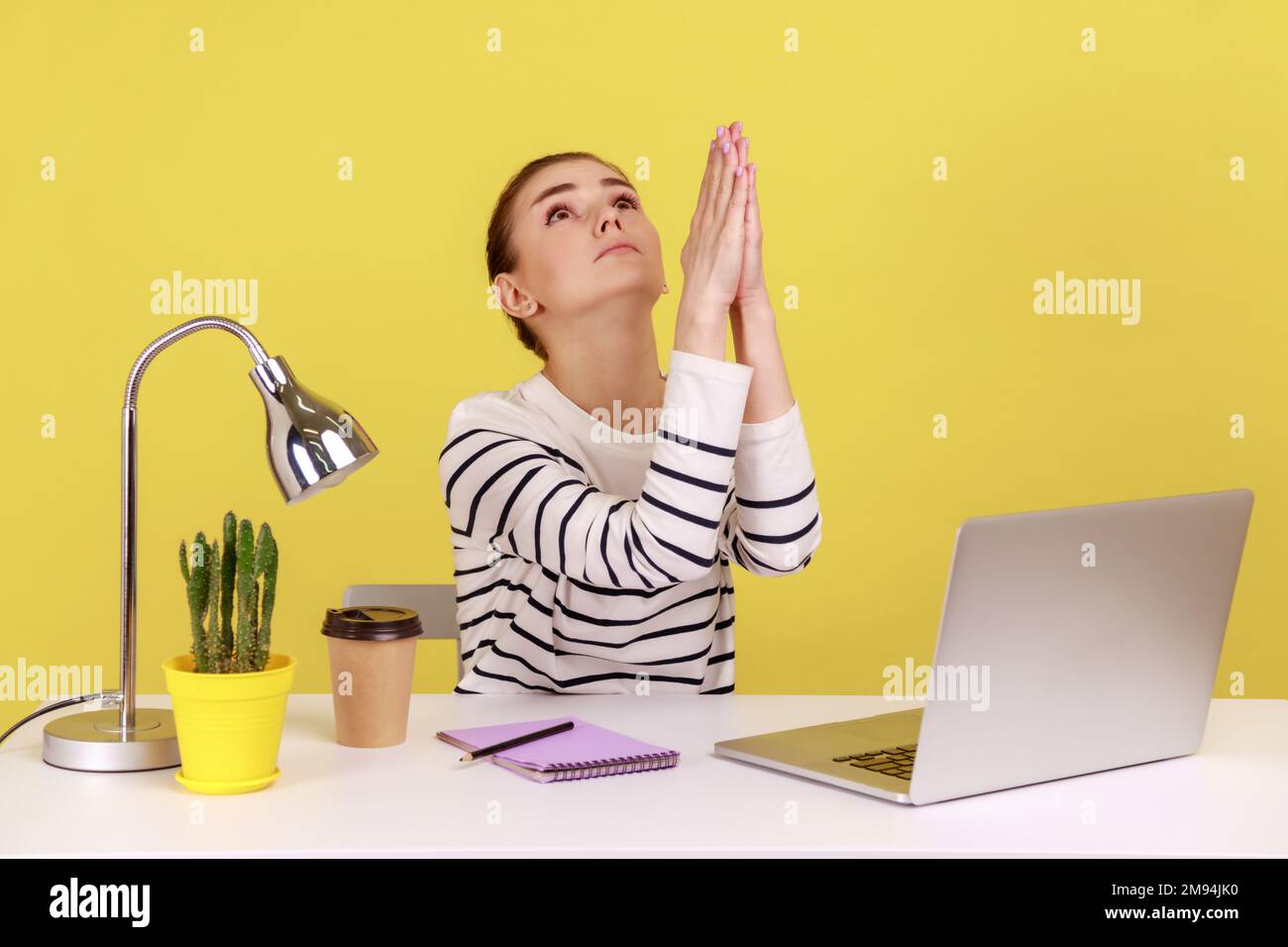 Please, god help. Dark haired woman employee sitting at workplace and ...