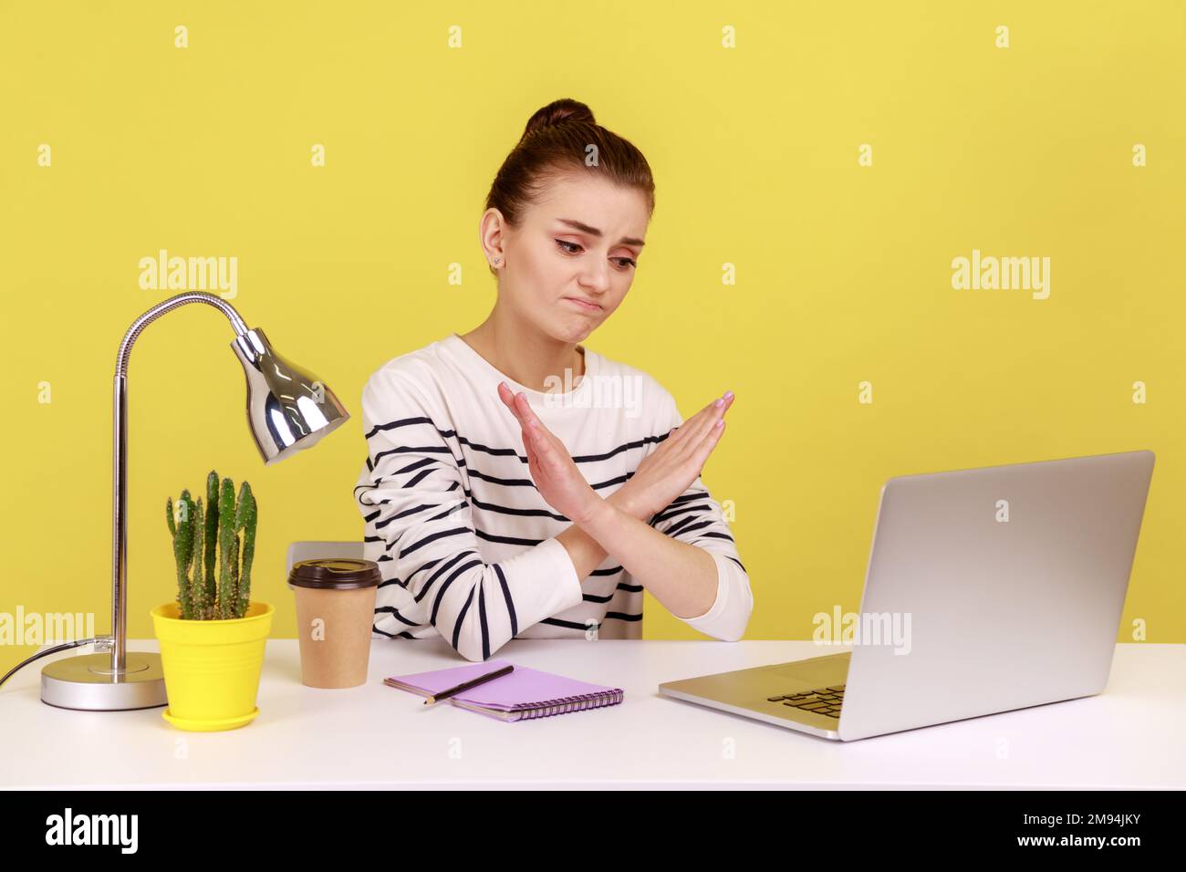 Upset sad woman manager sitting at workplace crossing hands showing x ...