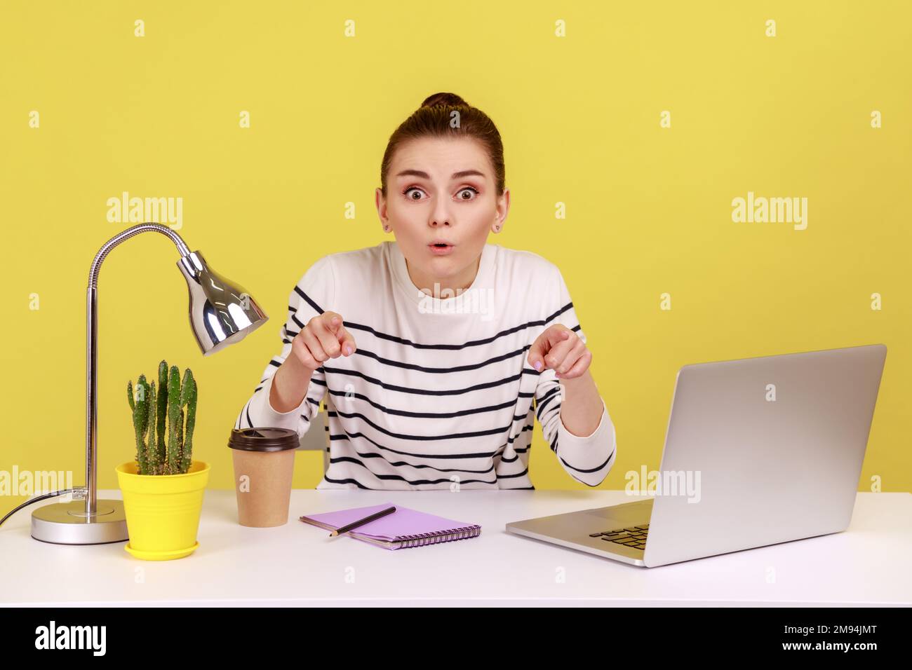 Extremely shocked woman office worker in striped shirt sitting ...