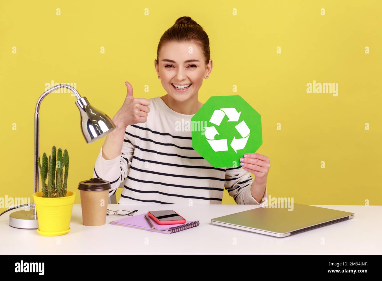 Responsible positive smiling happy woman holding green recycling sign ...