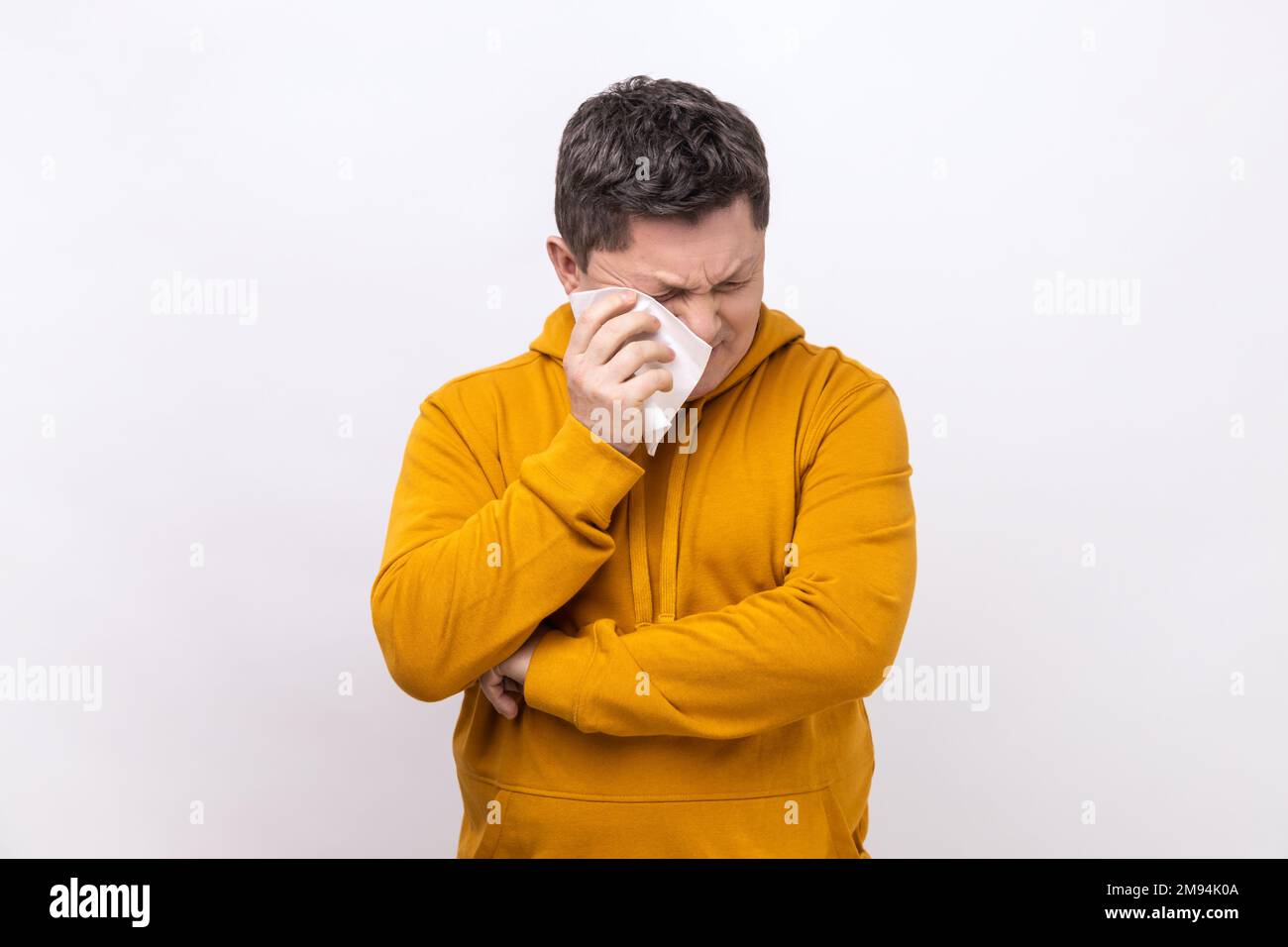 Depressed desperate middle aged man rubbing tired eyes, crying because ...