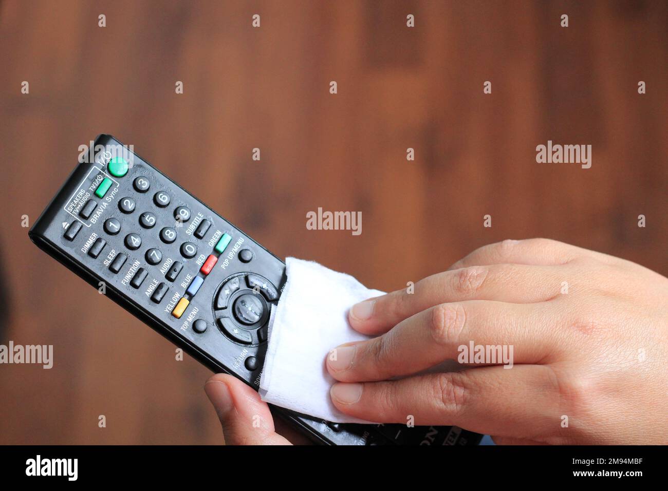 Hygiene at home, clean and disinfect remote control with an ...