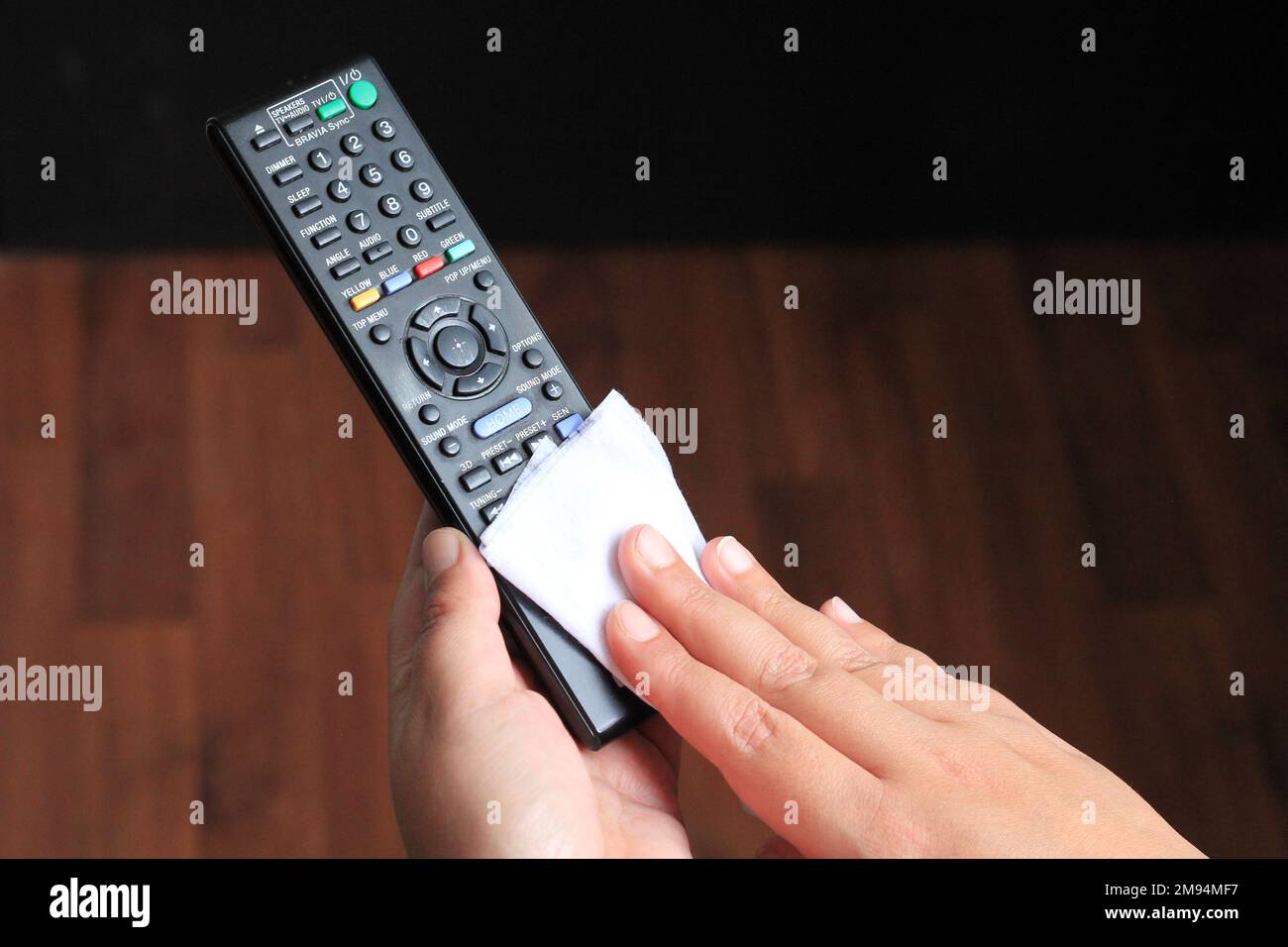 Hygiene at home, clean and disinfect remote control with an ...