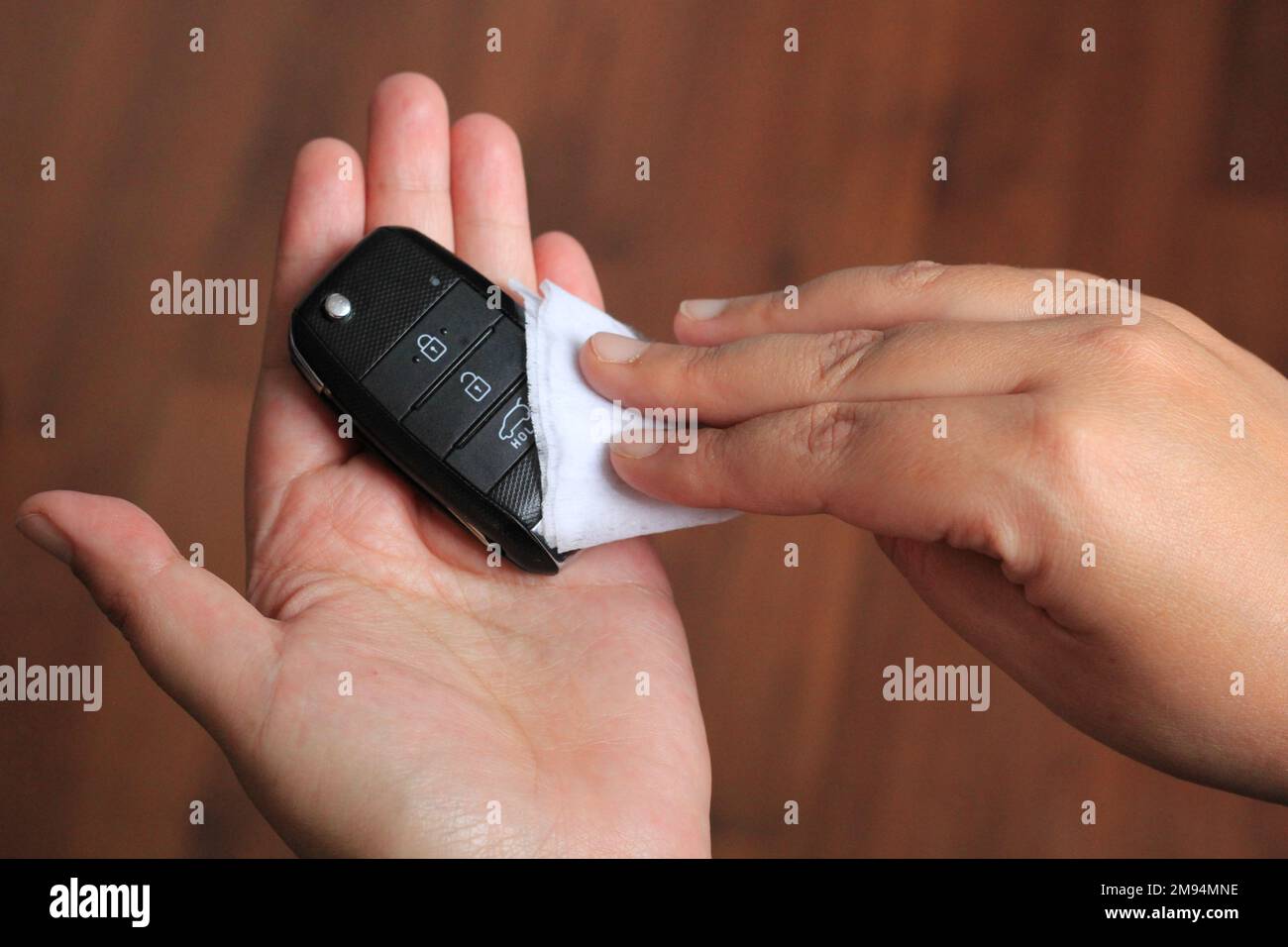 Hygiene at home, Clean the car key with a damp antibacterial towel, virus prevention Stock Photo ...