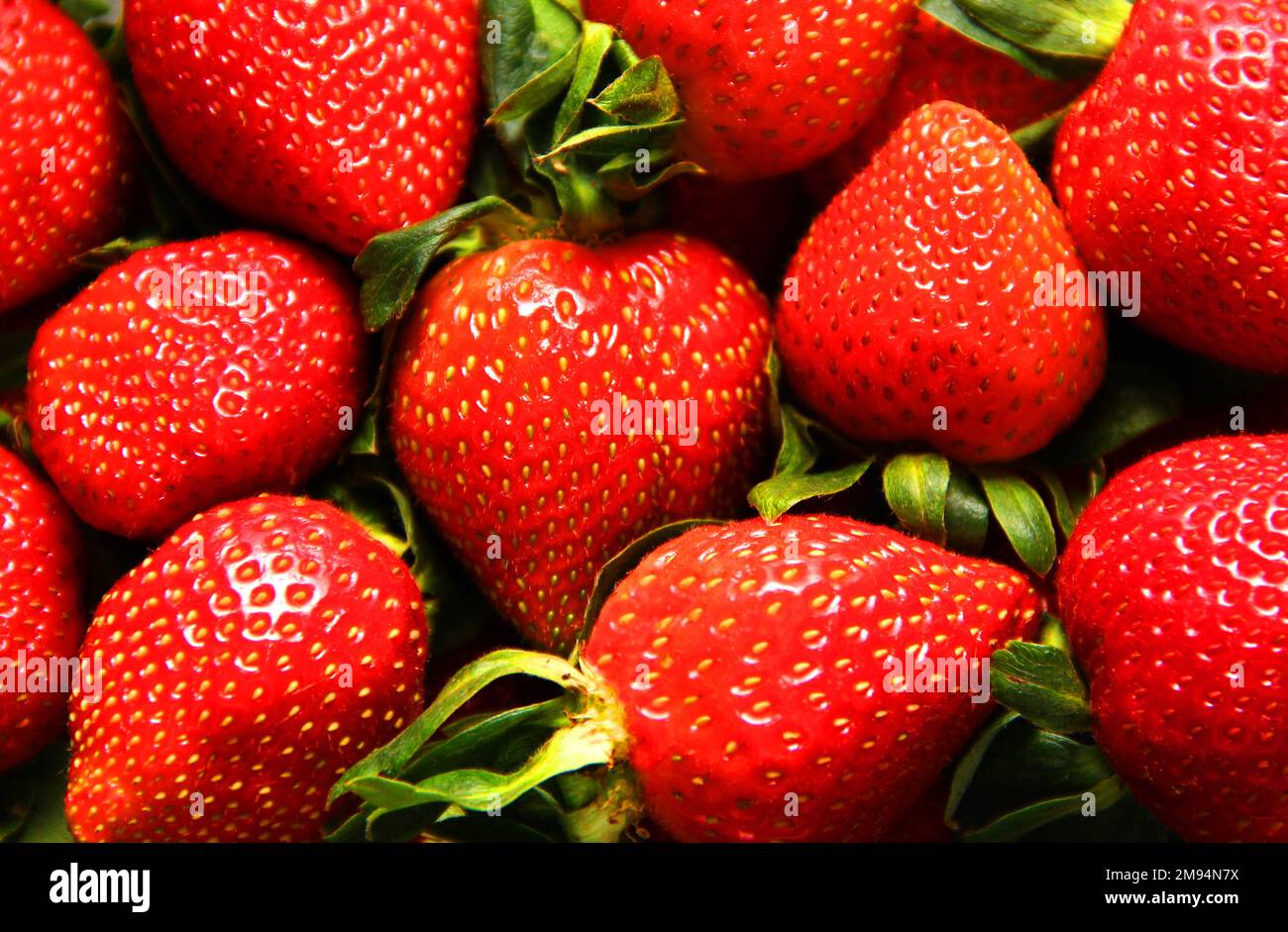 Select fruit, red strawberries in plastic packaging, vintage gray wood ...