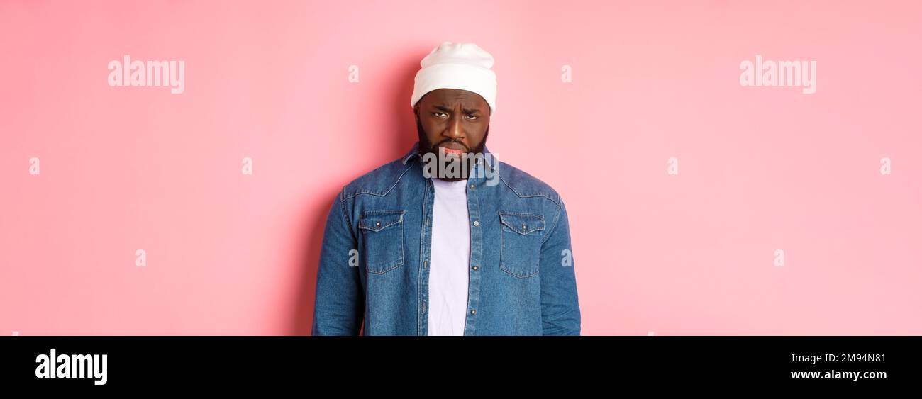 Disappointed and sad Black man, sulking and whining, looking at camera ...