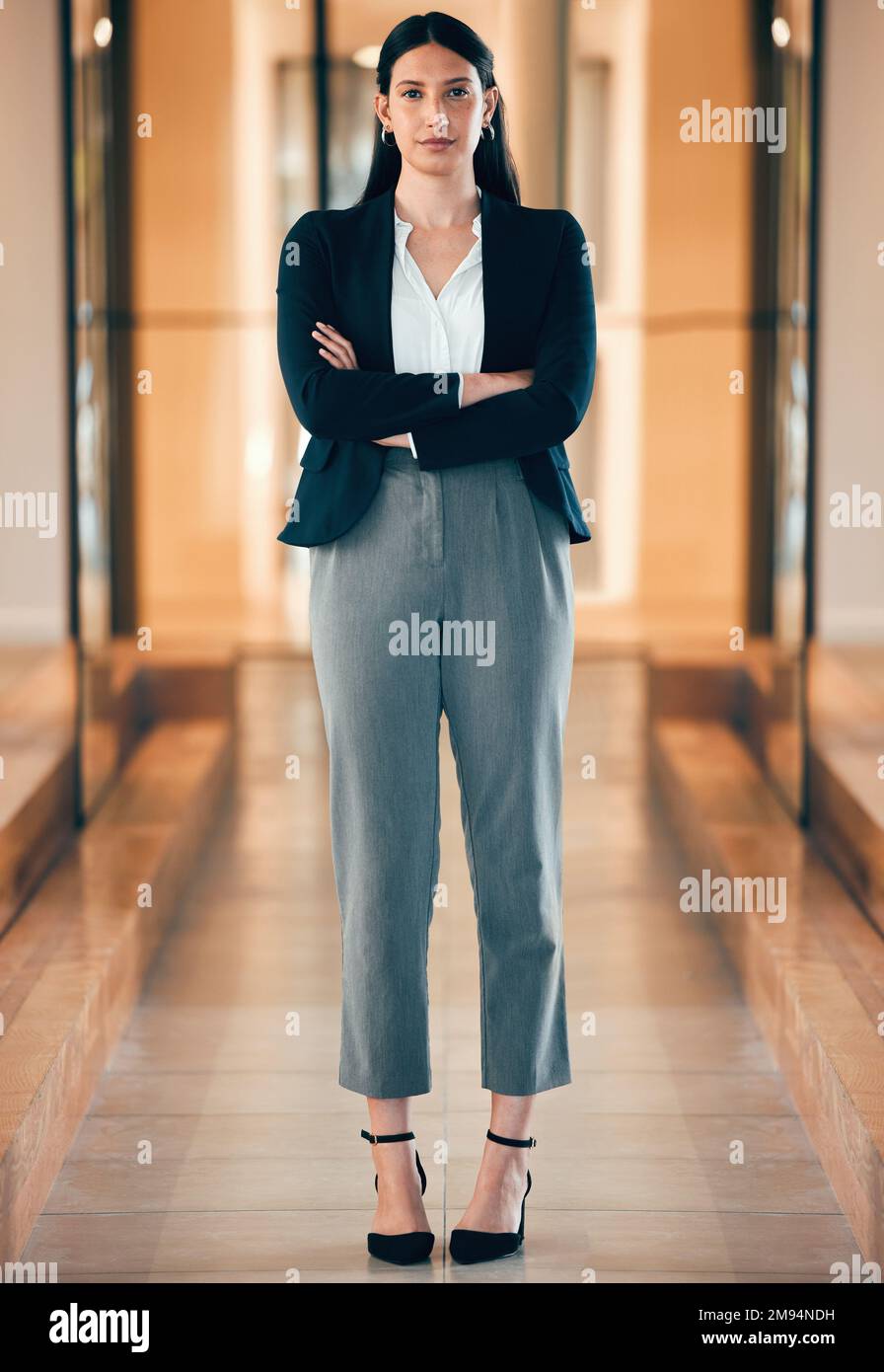 Keeping my arms crossed. a young businesswoman standing with her arms ...
