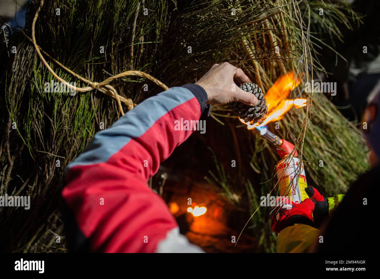 A man lights a bonfire during the festivities of the luminaries. The ...